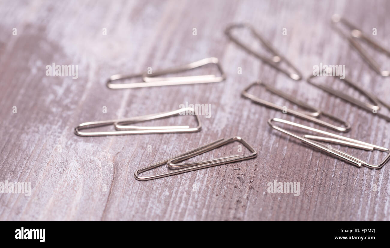 heap of metal clips on a wooden table Stock Photo - Alamy