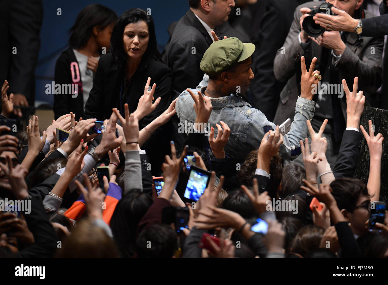New York, USA. 20th Mar, 2015. Singer Pharrell Williams (in green cap ...