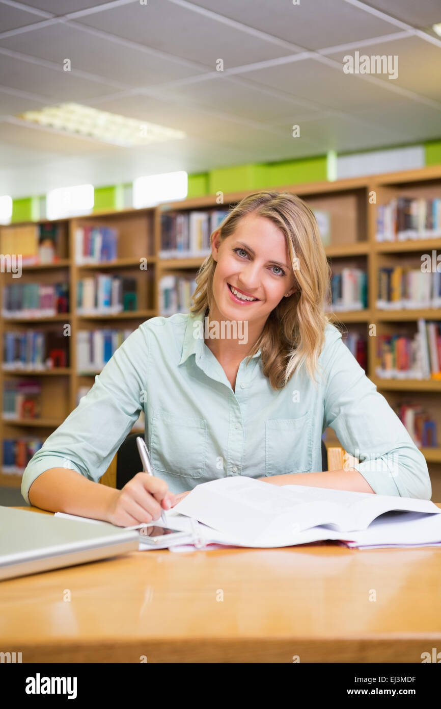 Pretty student studying in the library Stock Photo - Alamy