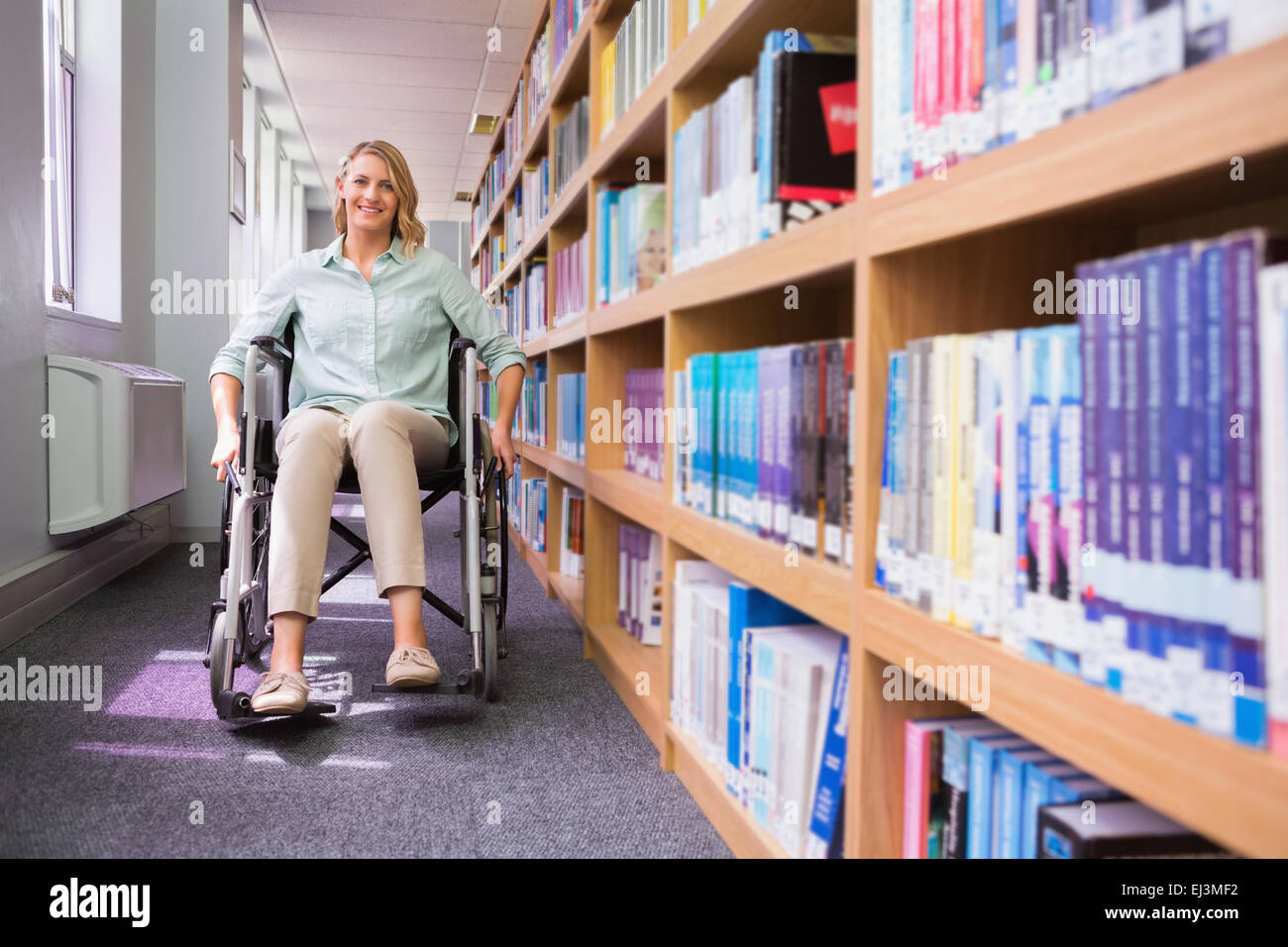 Smiling disabled student in library Stock Photo - Alamy