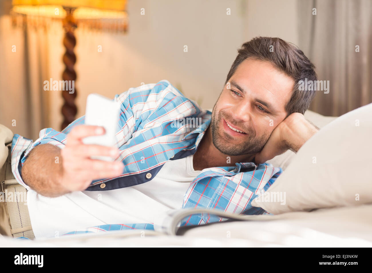 Handsome man relaxing on his bed Stock Photo - Alamy