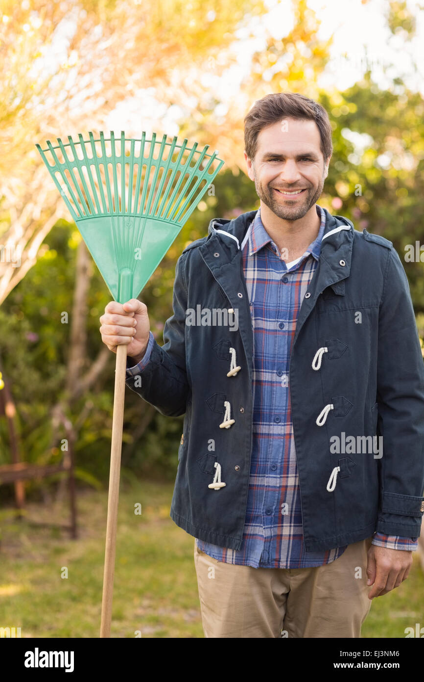 Handsome man smiling in his garden Stock Photo - Alamy