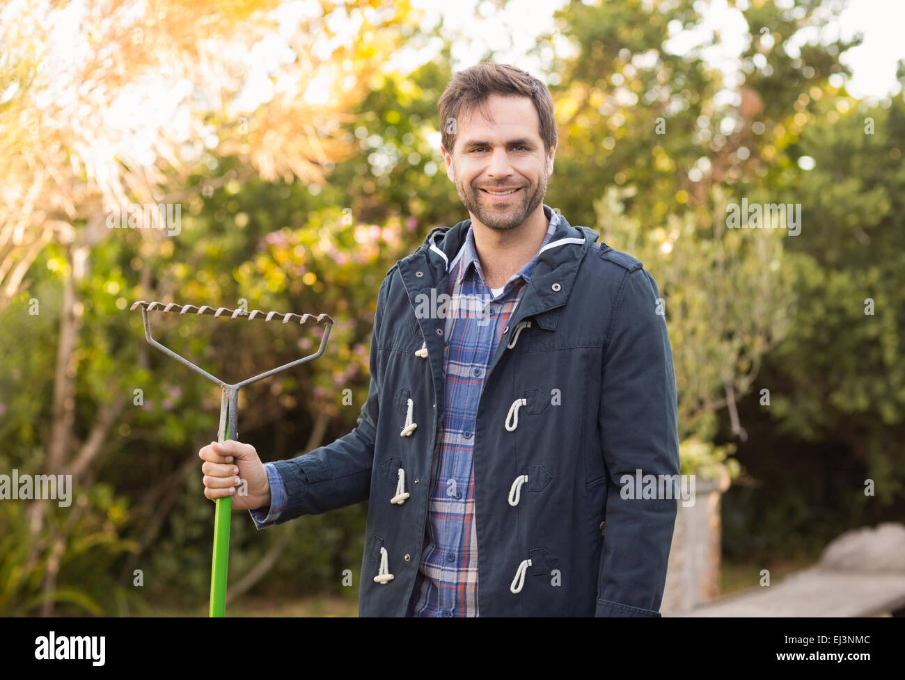 Man raking in his garden Stock Photo - Alamy