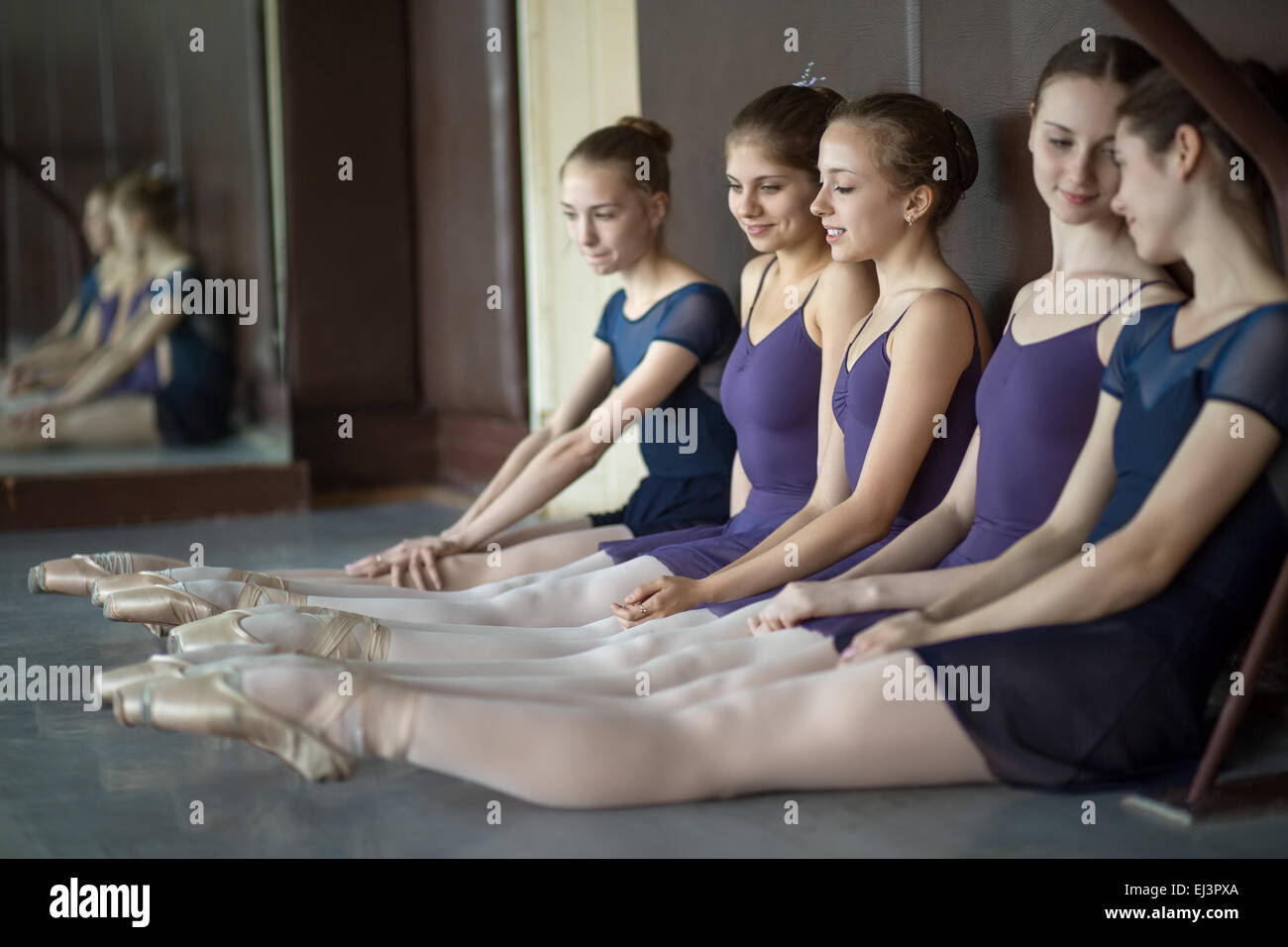 Five young dancers in the same dance costumes, resting sitting o Stock ...