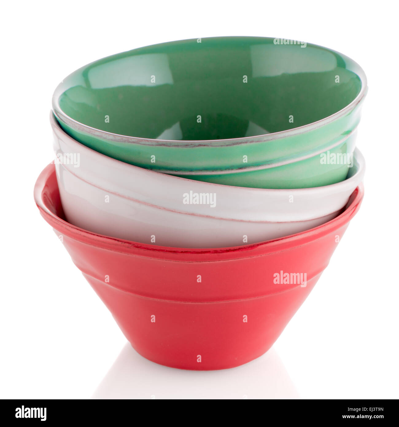 Three colored bowls on white reflective background Stock Photo - Alamy