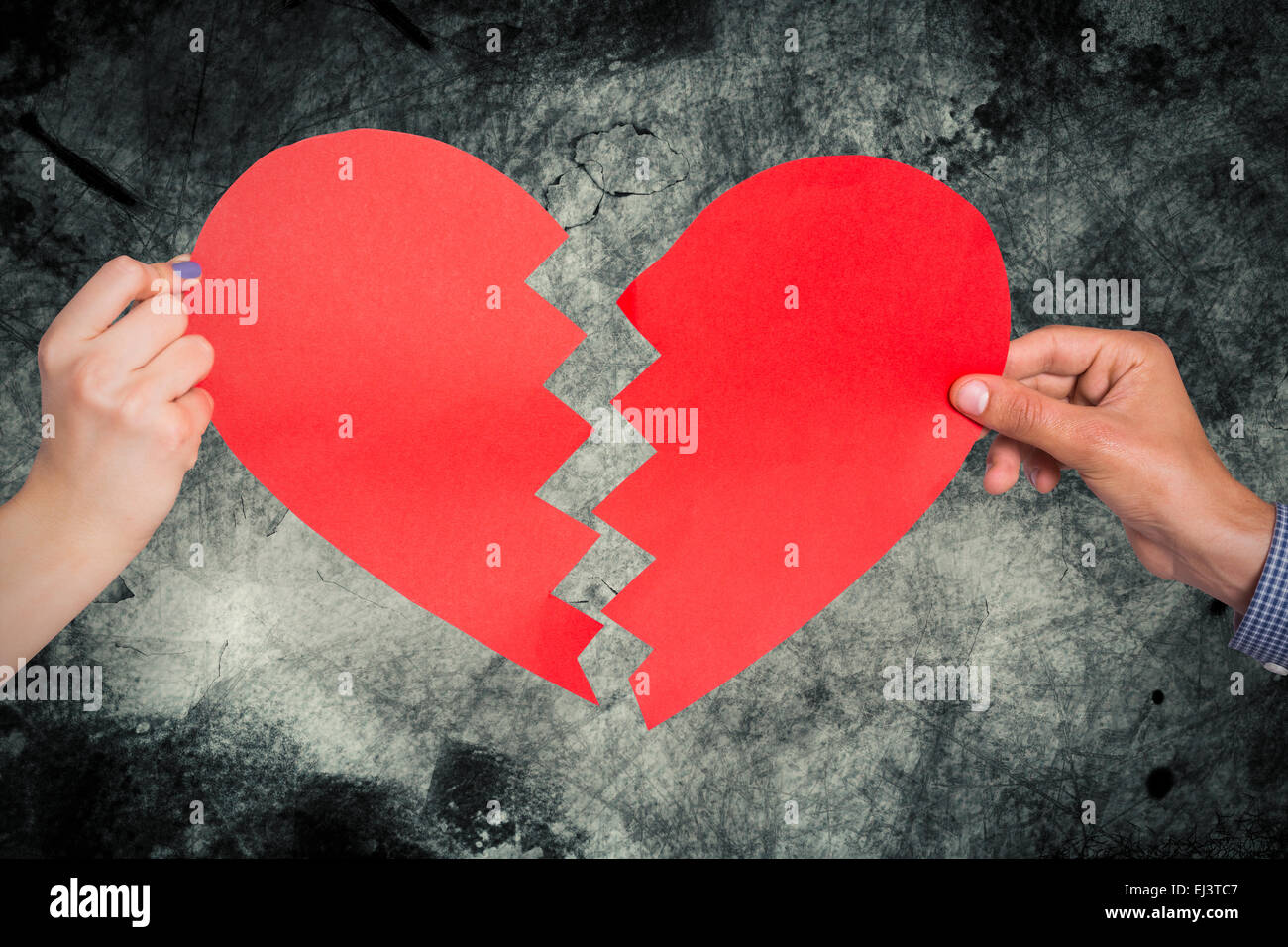 Composite image of two hands holding broken heart Stock Photo - Alamy