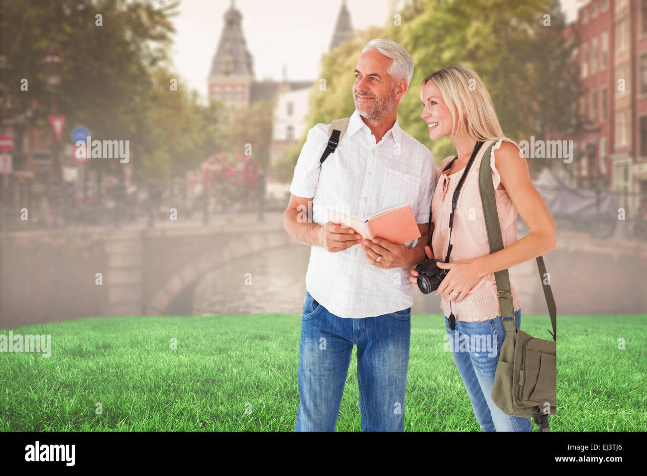 Composite image of happy tourist couple using the guidebook Stock Photo ...