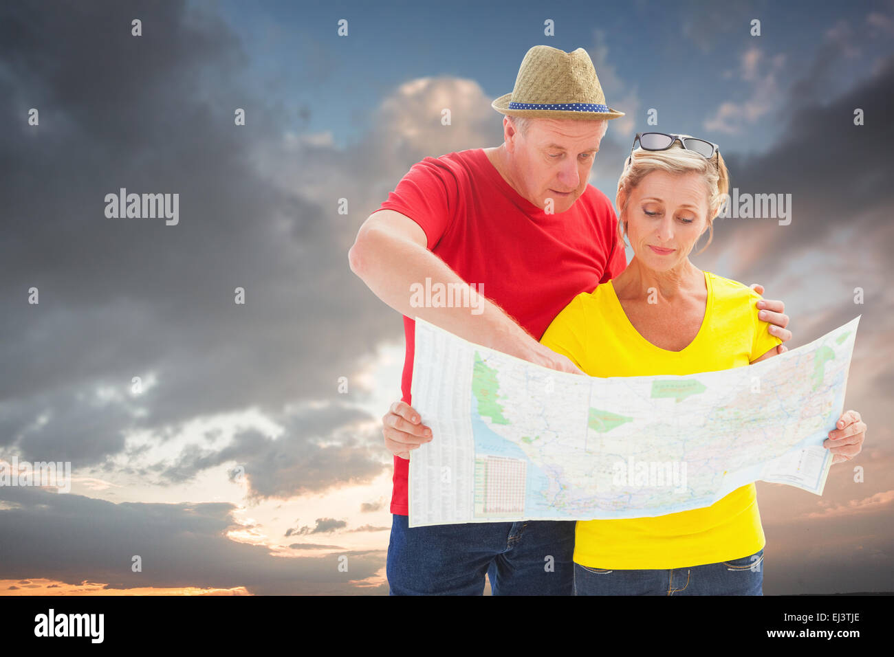 Composite image of lost tourist couple using map Stock Photo - Alamy