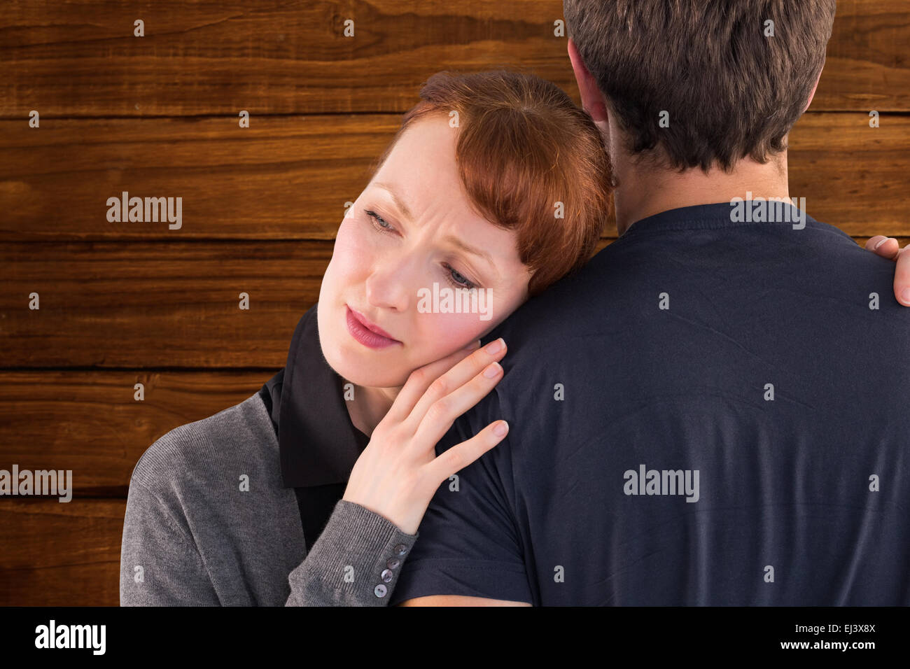 Composite image of scared woman holding onto man Stock Photo - Alamy