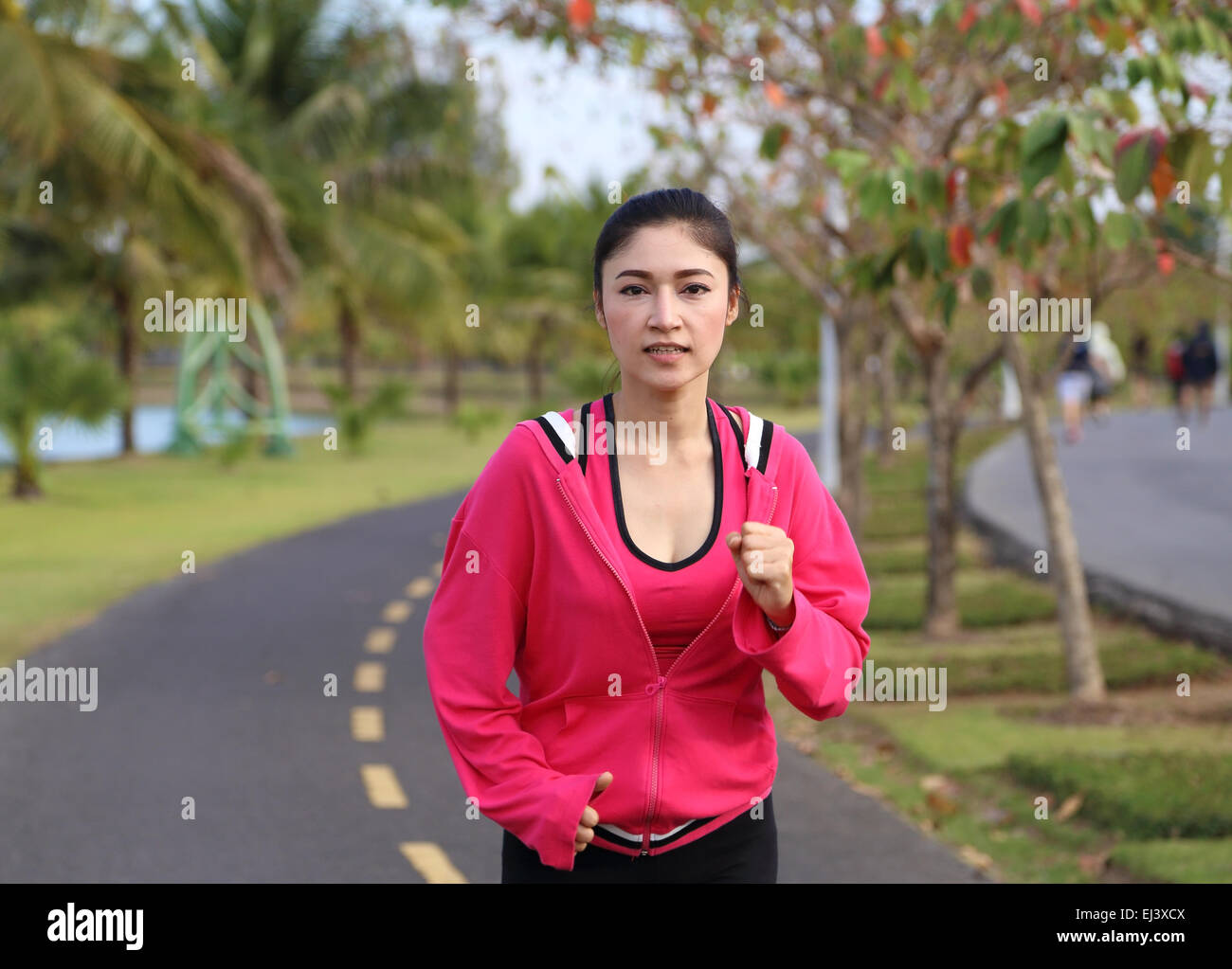 young healthy asian woman running in the park Stock Photo - Alamy