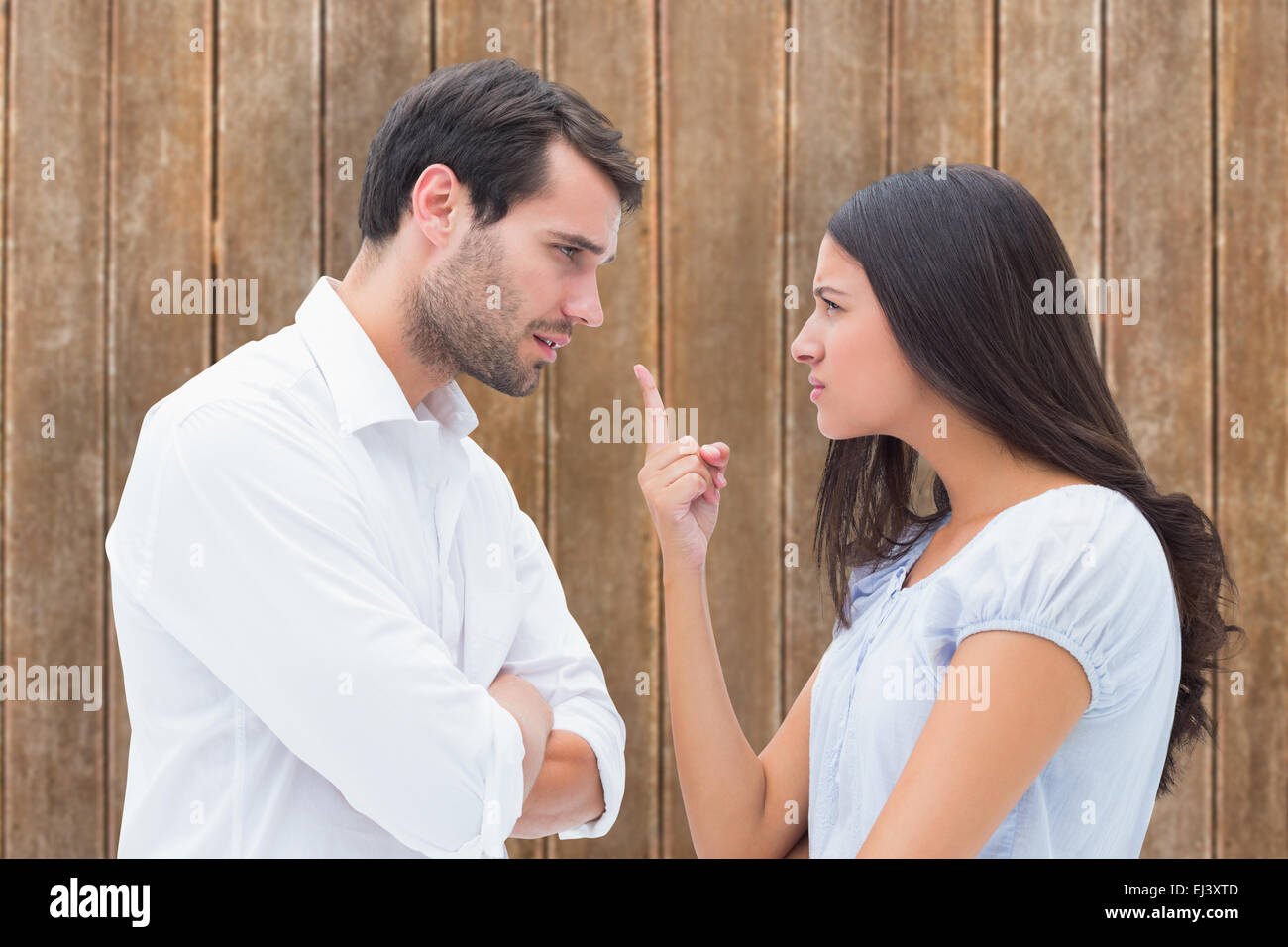Composite image of angry couple facing off during argument Stock Photo ...