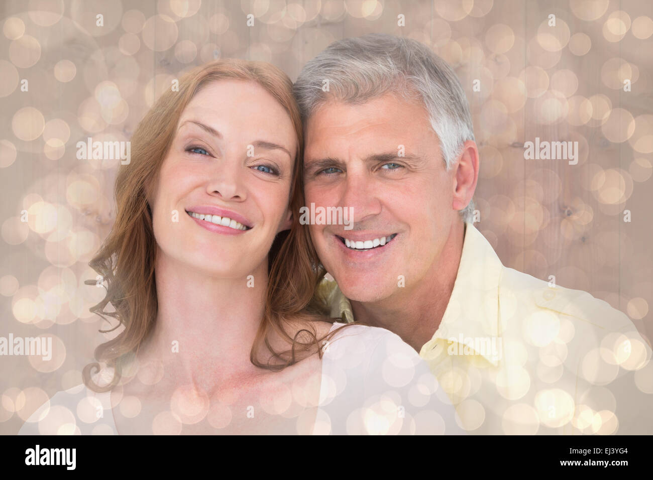 Composite image of casual couple hugging and smiling Stock Photo - Alamy