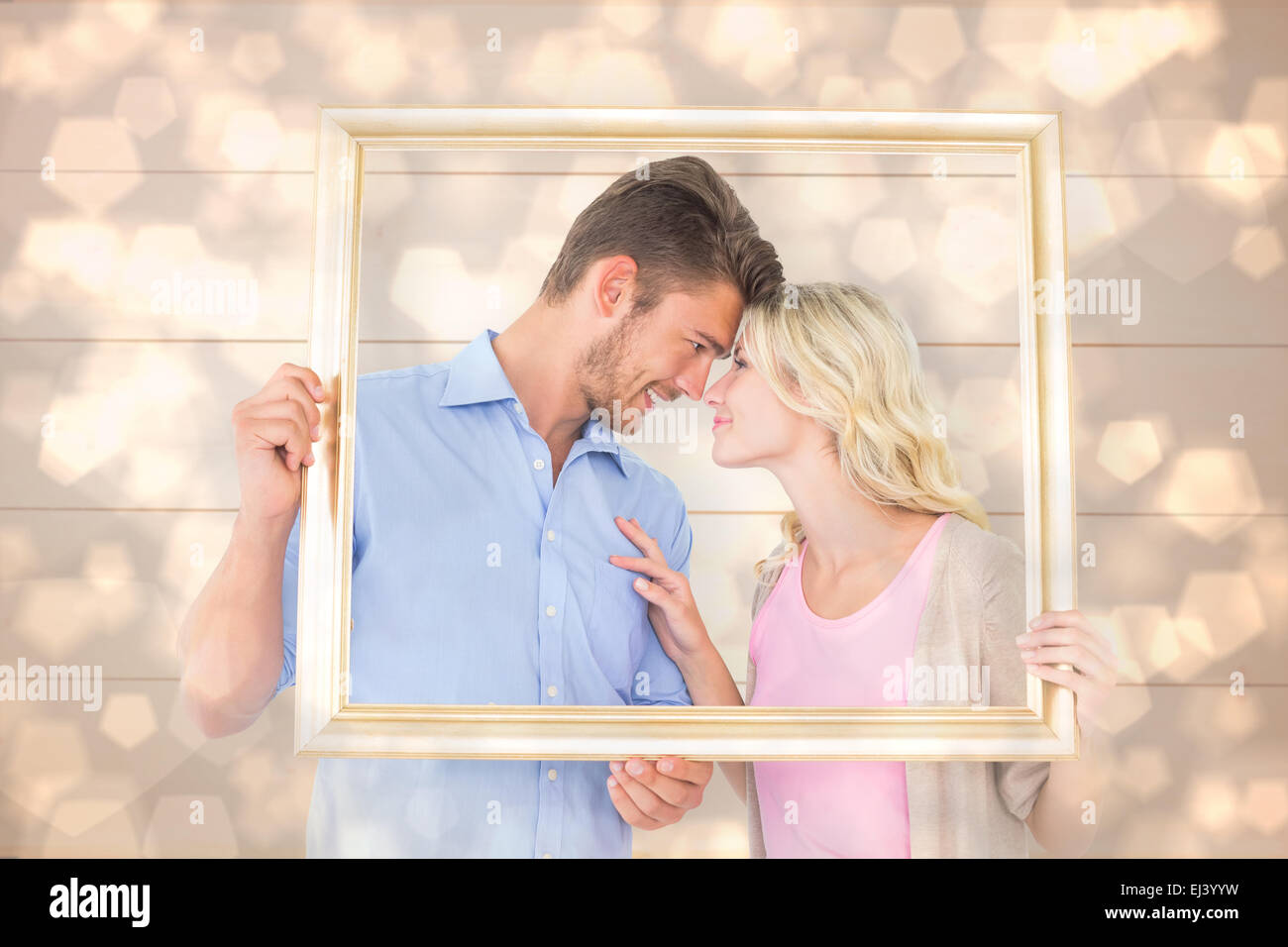 Composite image of attractive young couple holding picture frame Stock ...
