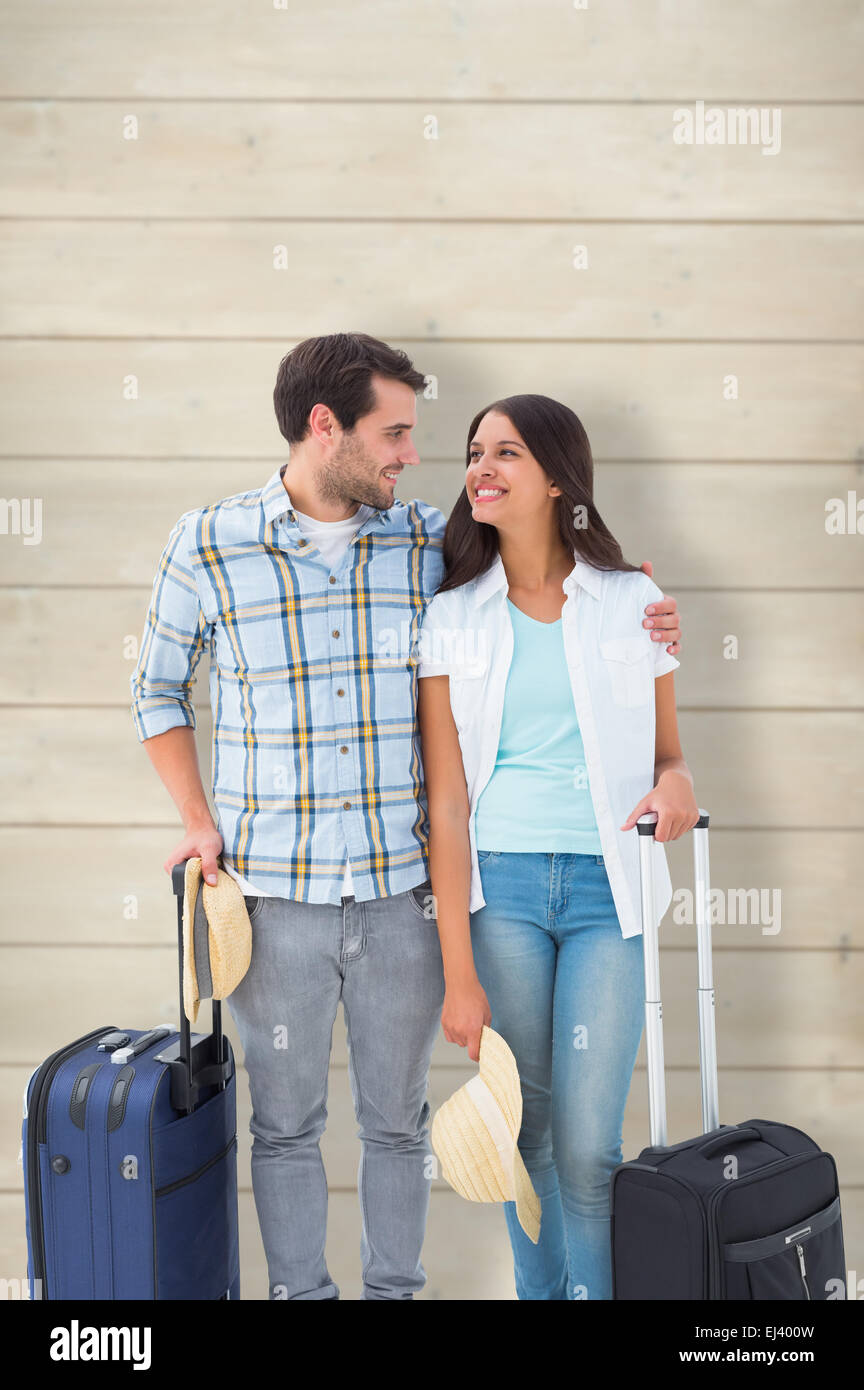 Composite image of attractive young couple going on their holidays ...
