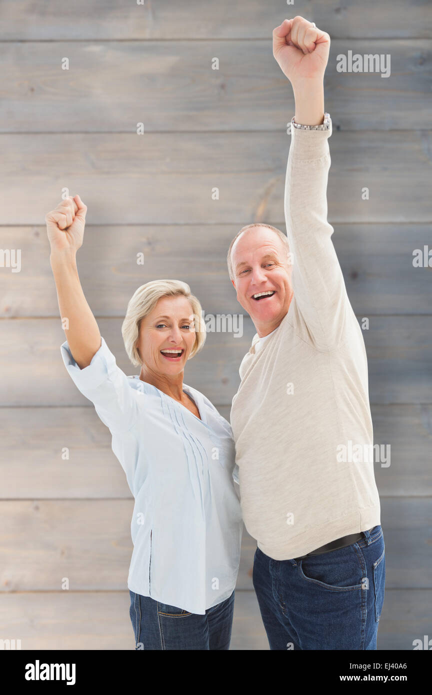 Composite image of happy mature couple cheering at camera Stock Photo ...