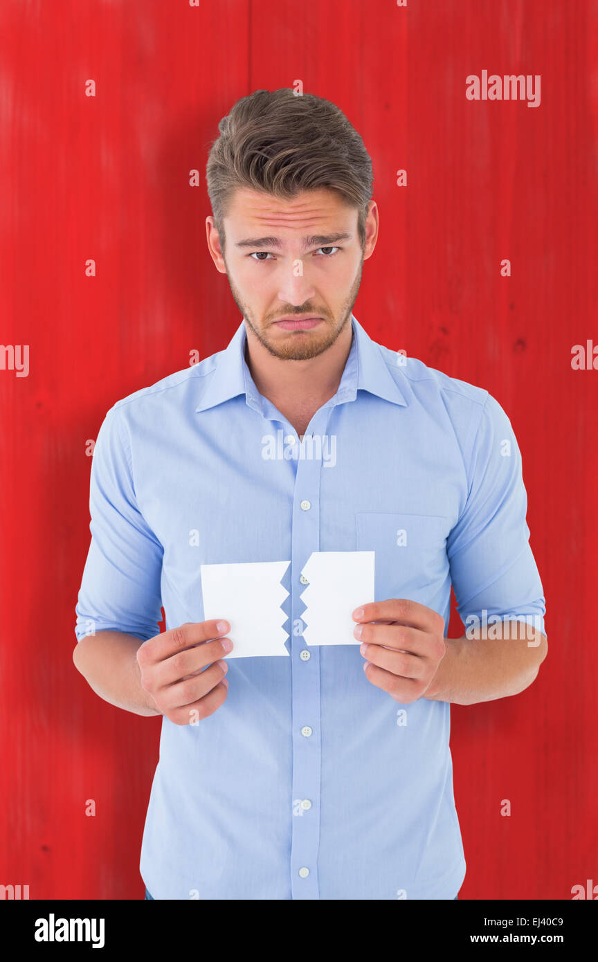 Composite image of sad man holding a broken card Stock Photo - Alamy