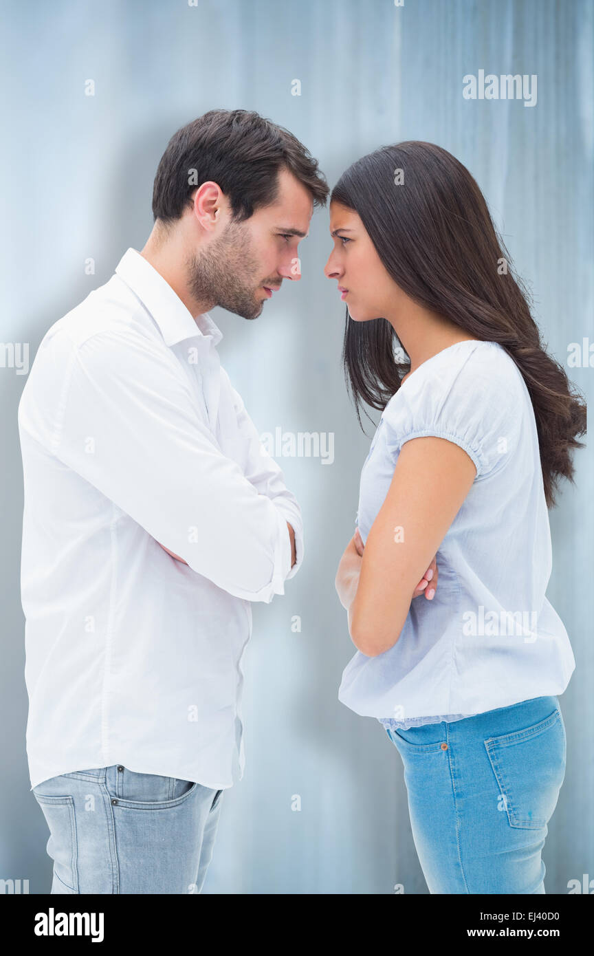 Composite image of angry couple facing off after argument Stock Photo ...
