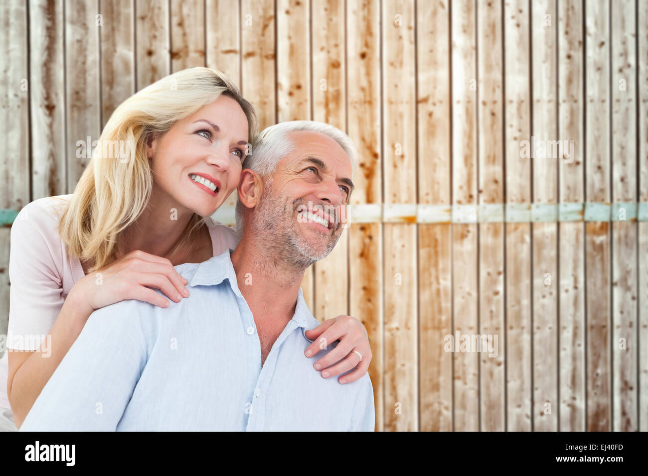 Composite image of smiling couple embracing and looking Stock Photo - Alamy