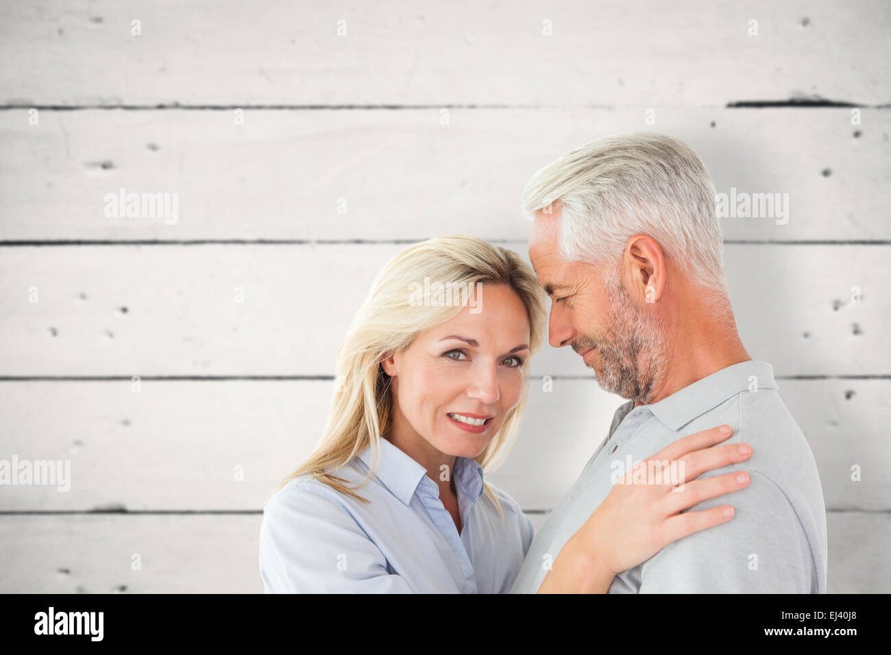Composite image of happy couple standing and smiling at camera Stock ...