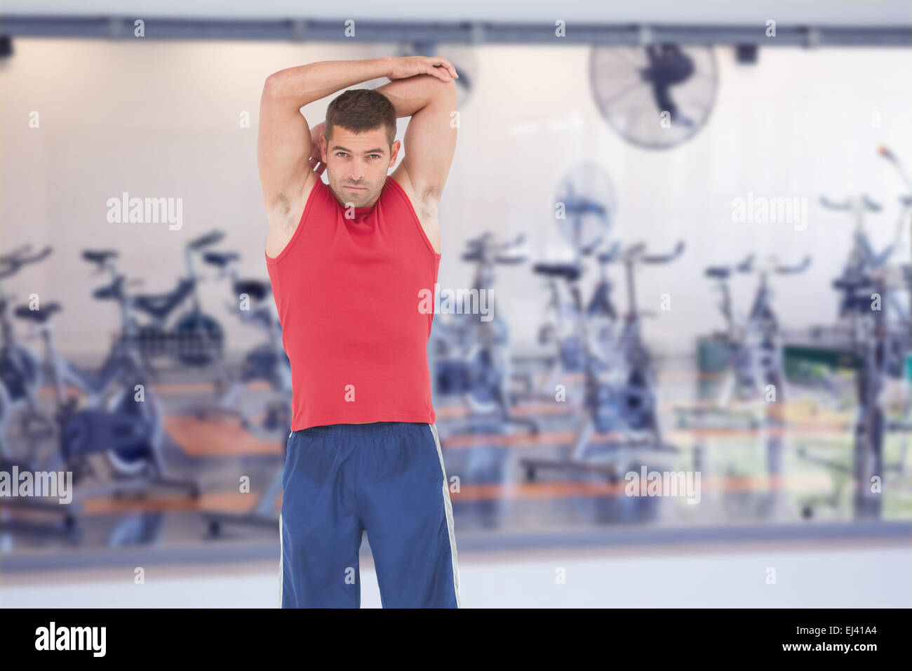 Composite image of fit man stretching his arms Stock Photo - Alamy