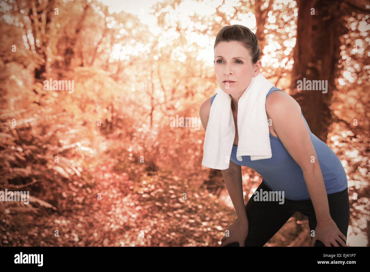 Composite image of fit woman with towel on shoulders Stock Photo - Alamy