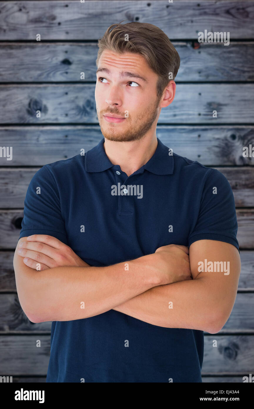 Composite image of handsome young man thinking with arms crossed Stock ...