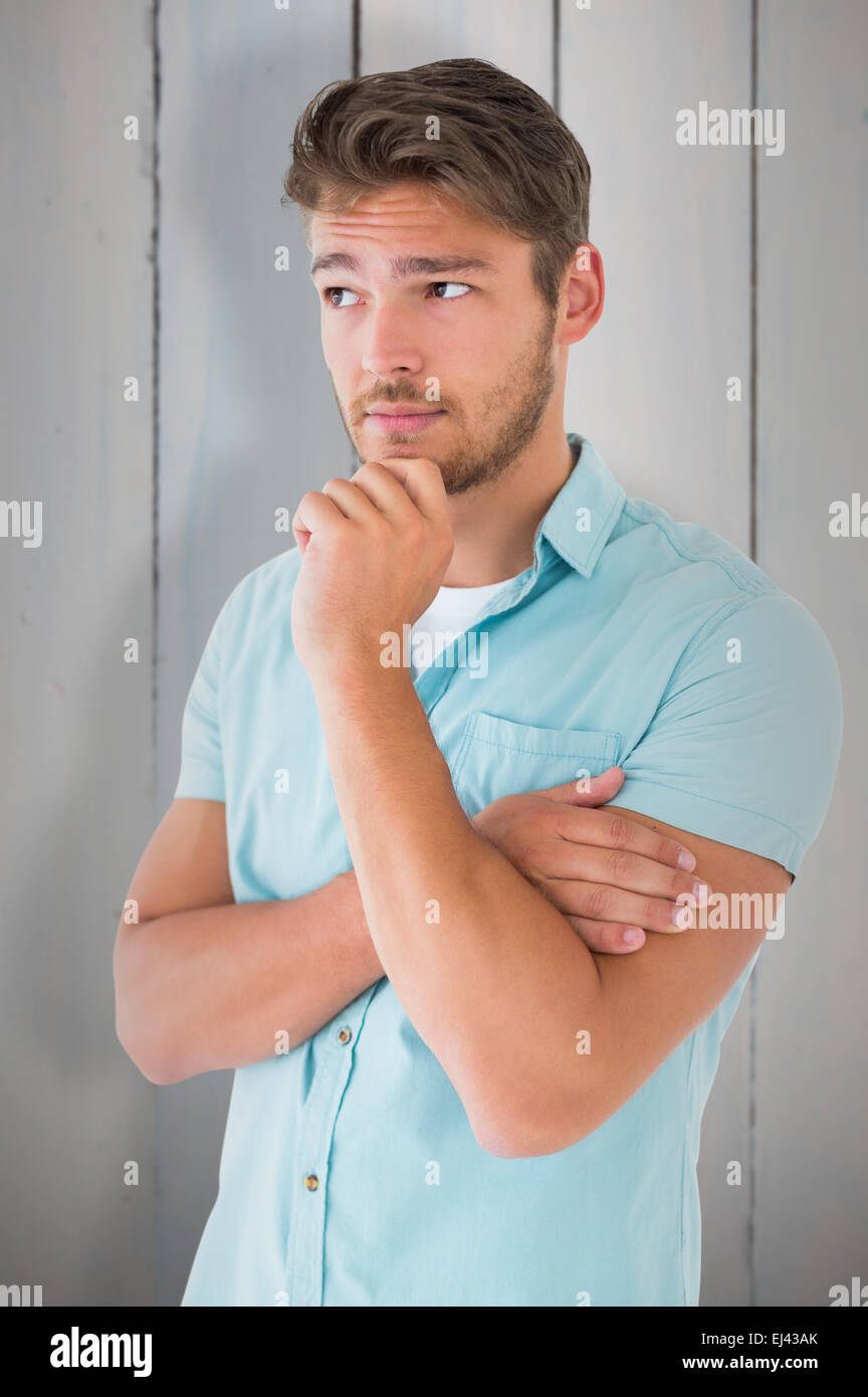 Composite image of handsome young man thinking with hand on chin Stock ...
