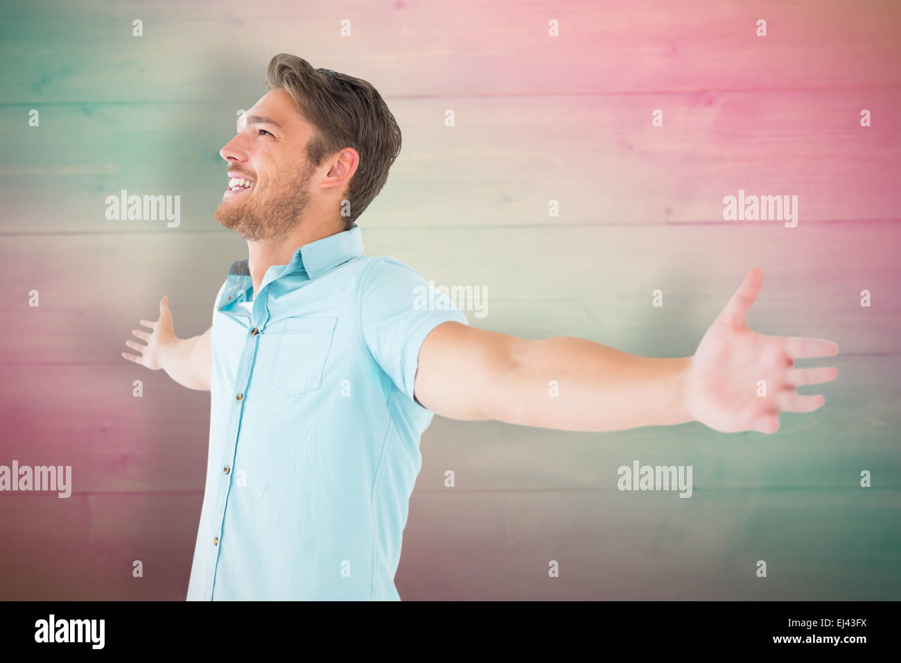 Composite image of handsome young man posing with arms out Stock Photo ...