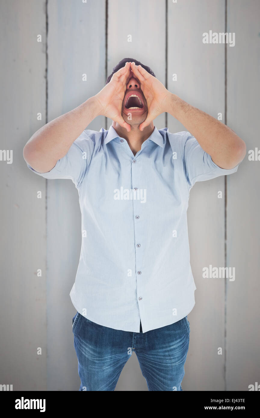 Composite image of shouting casual man standing Stock Photo - Alamy