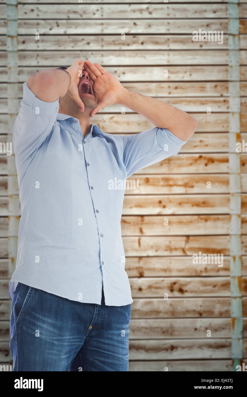 Composite image of shouting casual man standing Stock Photo - Alamy