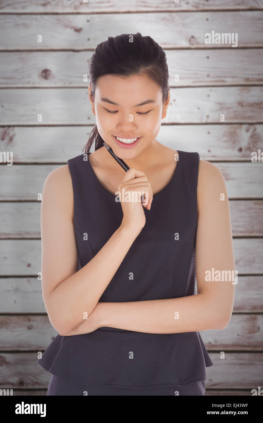 Composite image of thinking businesswoman Stock Photo - Alamy