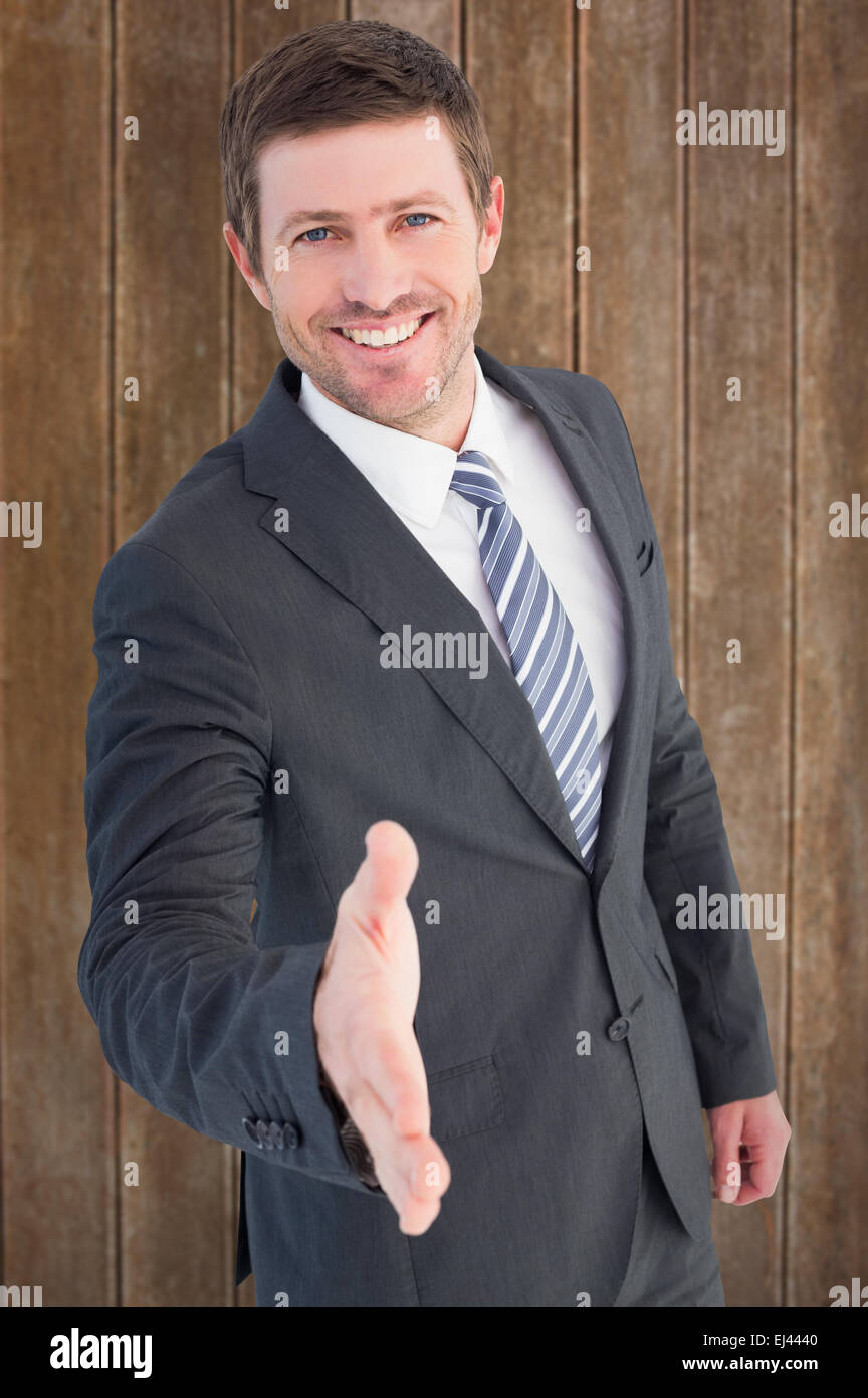 Composite image of businessman smiling and offering his hand Stock ... Composite image of businessman smiling and offering his hand Stock ...