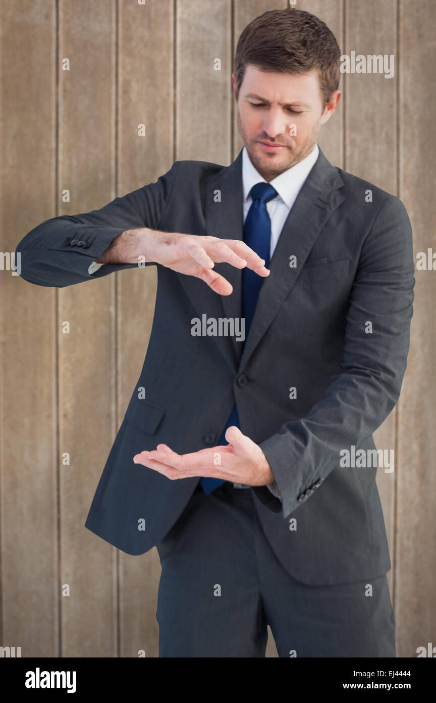 Composite image of businessman showing something with his hands Stock ...