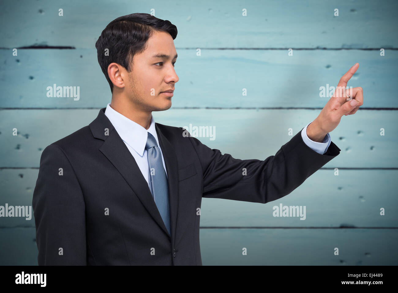 Composite image of stern asian businessman pointing Stock Photo - Alamy