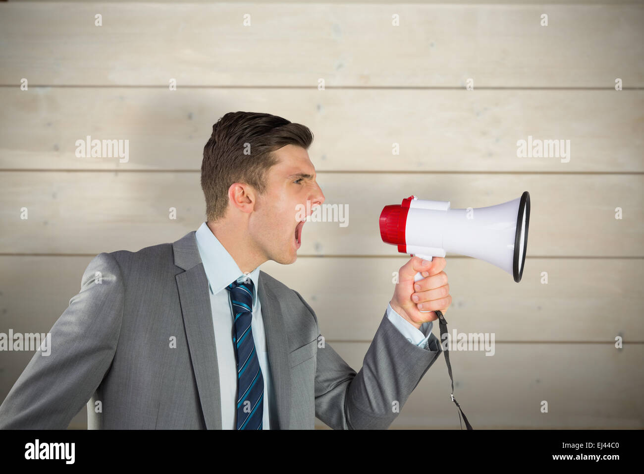 Composite image of businessman shouting in loudspeaker Stock Photo - Alamy
