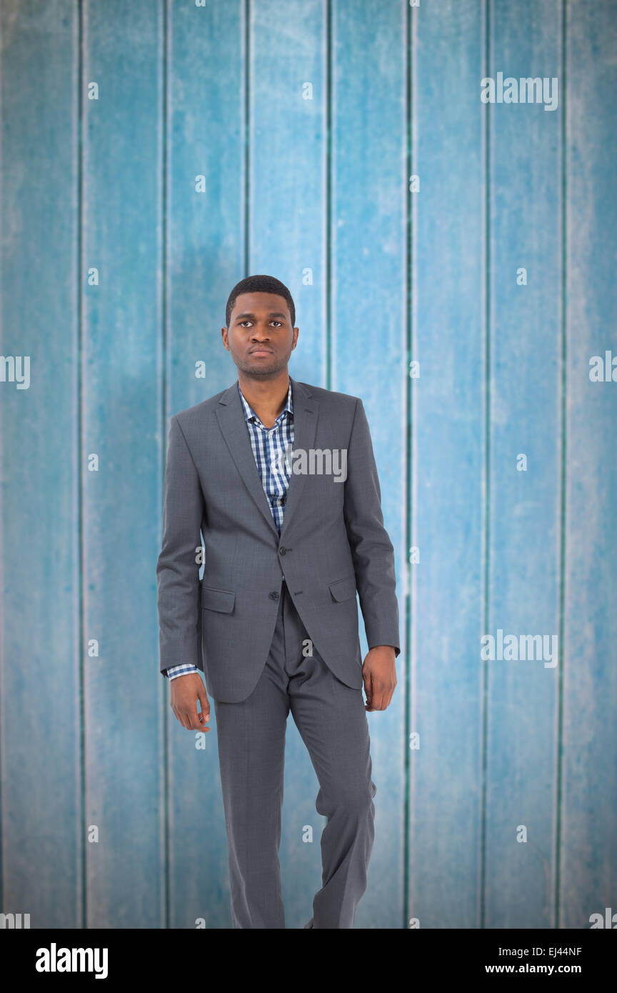 Composite image of businessman standing looking at camera Stock Photo ...