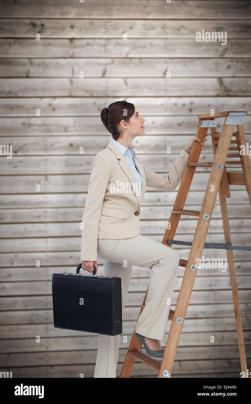 Composite image of businesswoman climbing career ladder with briefcase ...