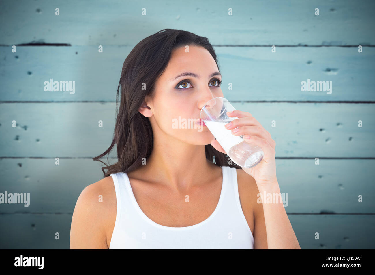 Composite image of pretty brunette drinking glass of water Stock Photo ...