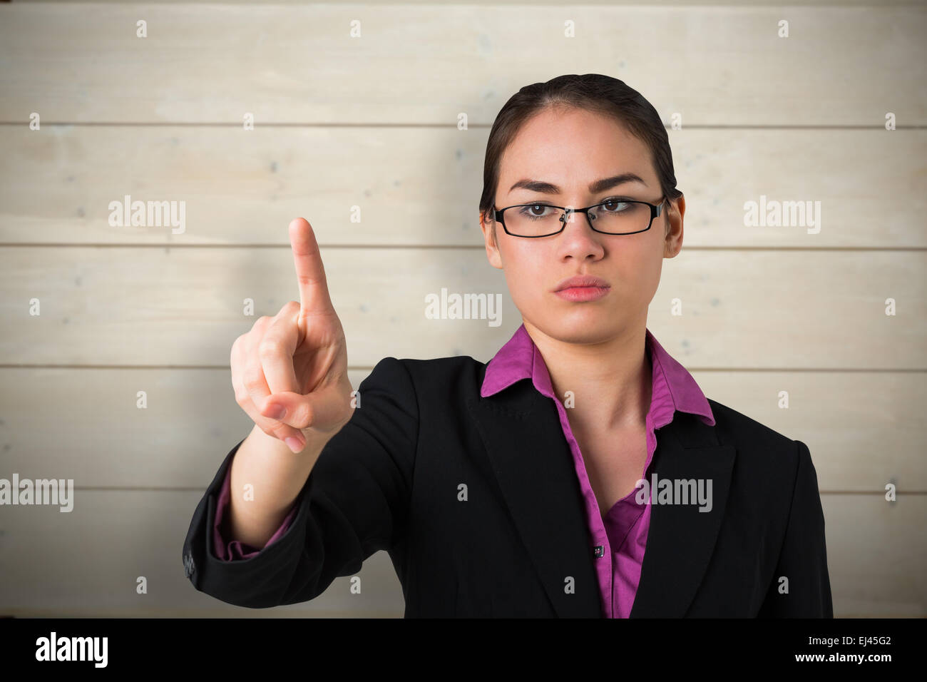 Composite image of serious businesswoman pointing Stock Photo - Alamy
