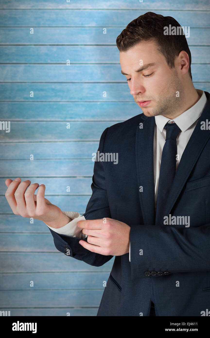 Composite image of businessman adjusting his cuffs on shirt Stock Photo ...