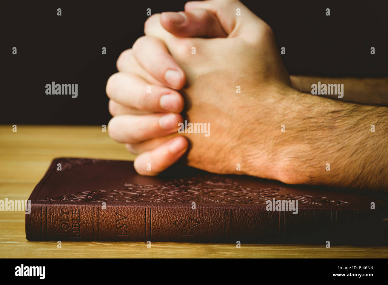 Man praying over his bible Stock Photo - Alamy