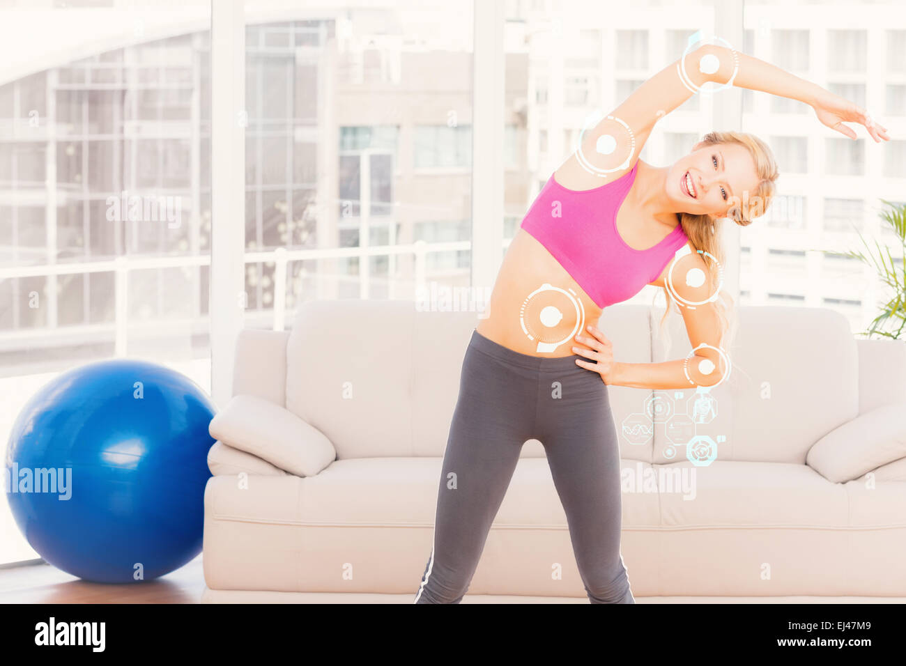 Composite image of blonde smiling at camera while stretching Stock ...