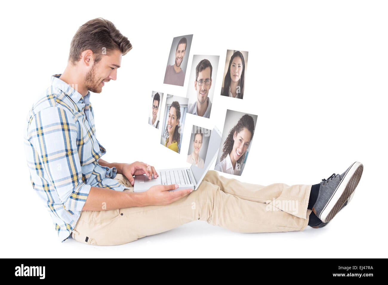 Composite image of handsome young man sitting using laptop Stock Photo ...