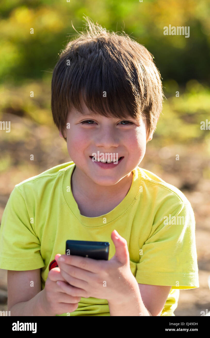 Boy playing with phone hi-res stock photography and images - Alamy