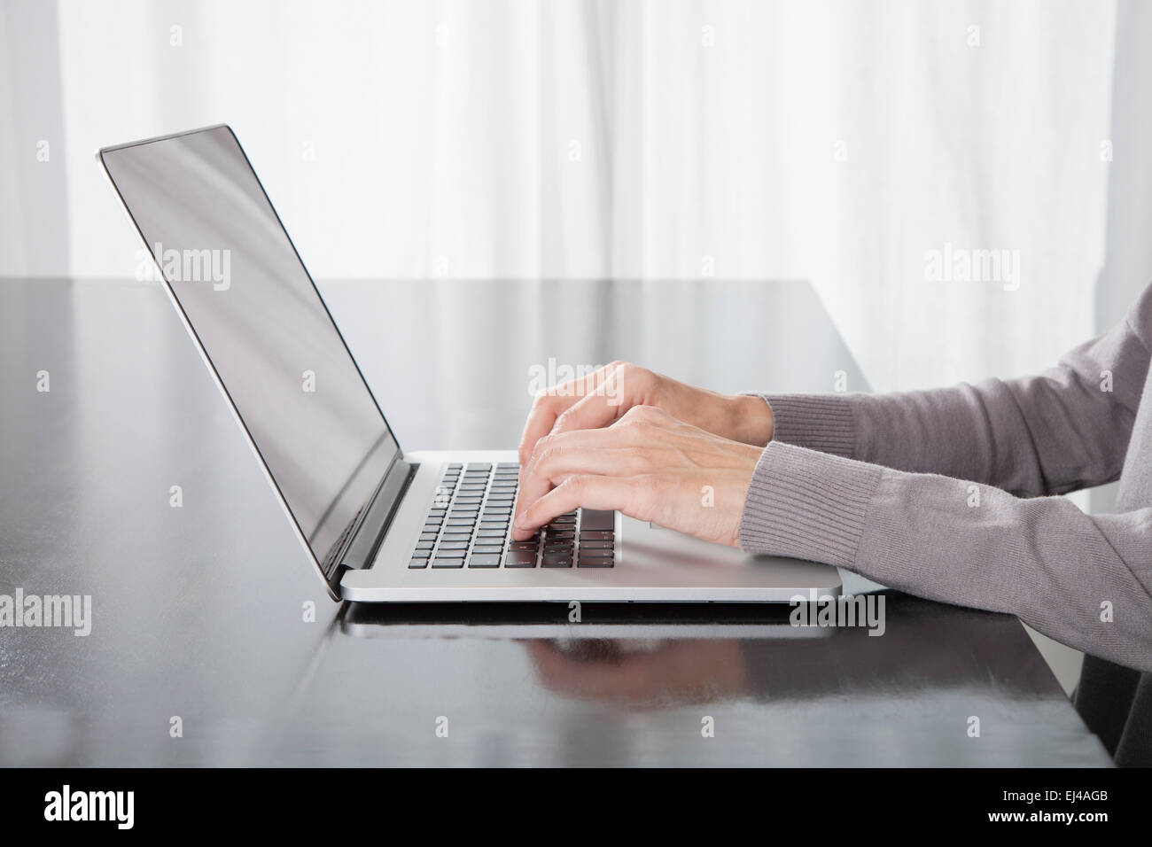 woman hands grey sweater typing in keyboard laptop computer blank ...
