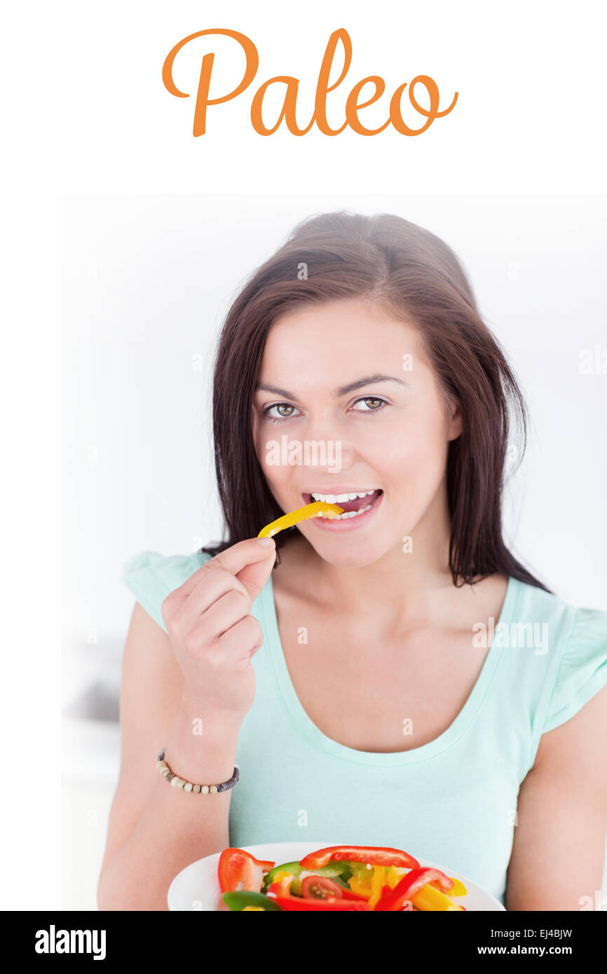 Paleo against beautiful woman eating a salad Stock Photo - Alamy