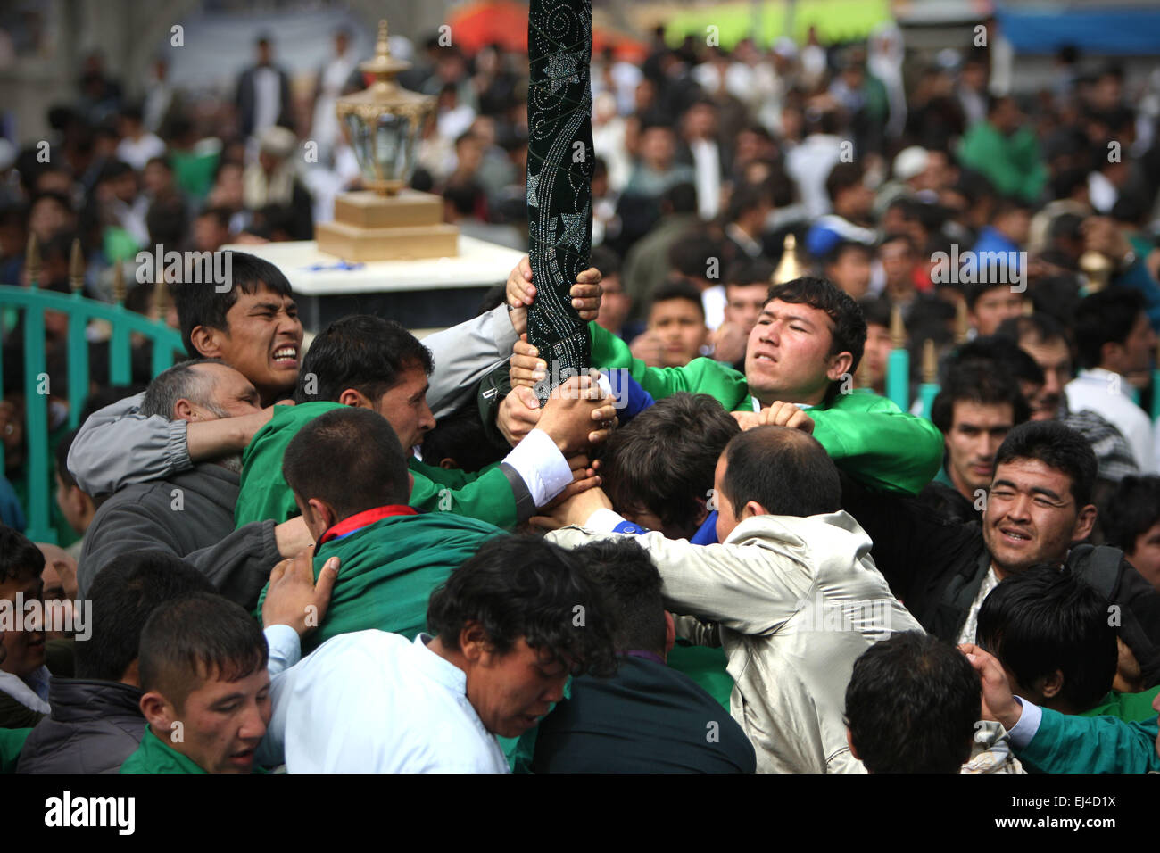 Kabul, Afghanistan. 21st Mar, 2015. Afghan men grasp a holy mace during ...
