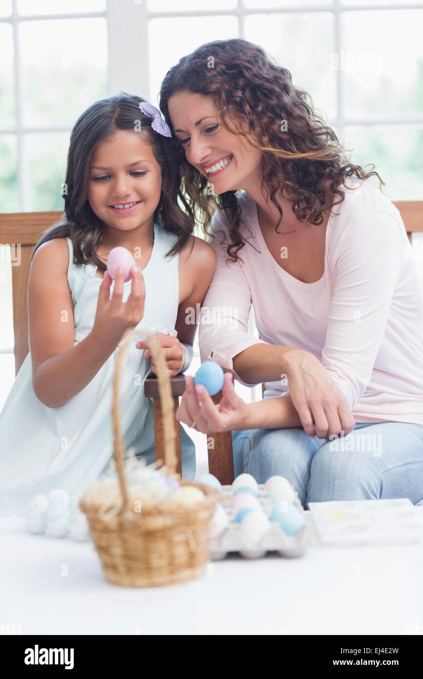 Happy mother and daughter holding easter eggs Stock Photo - Alamy
