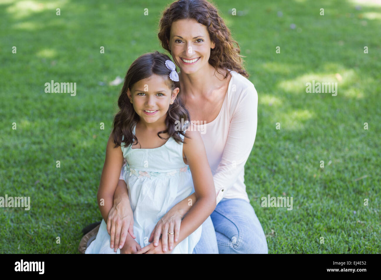 Mother daughter sitting on grass hi-res stock photography and images ...