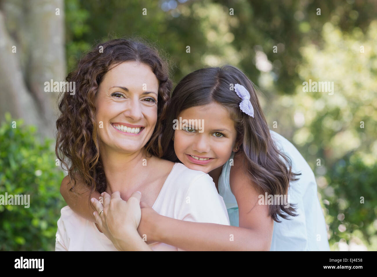 Happy Mother And Daughter Smiling At Camera Stock Photo Alamy